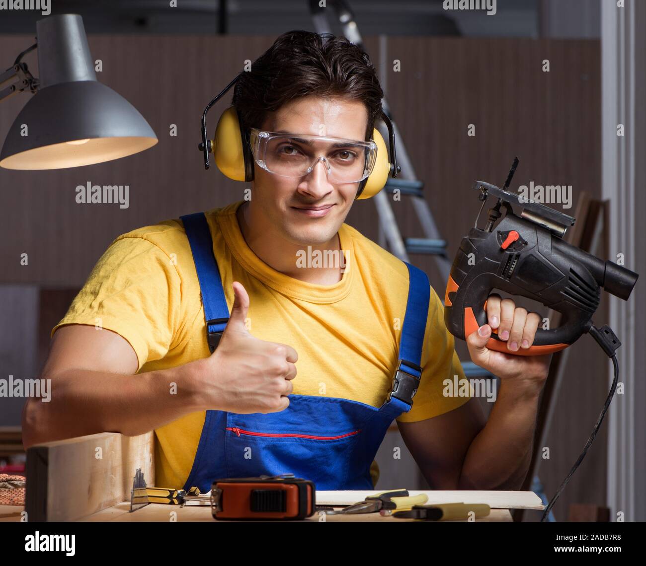 The worker working in repair workshop in woodworking concept Stock ...