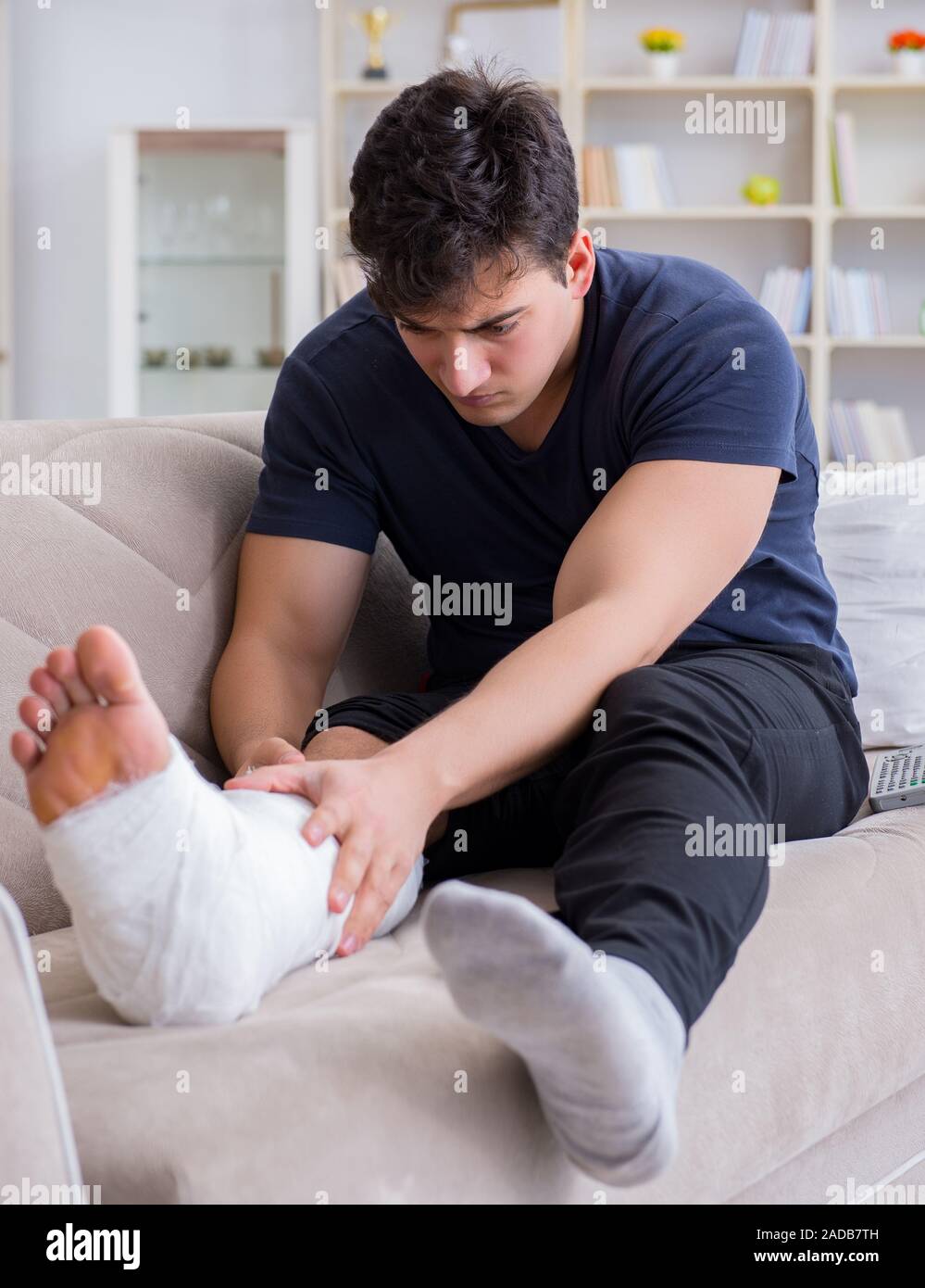 Man with broken leg recovering at home Stock Photo - Alamy