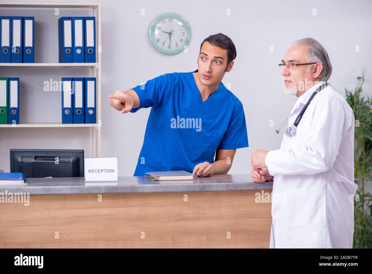 Two doctors talking at the reception in hospital Stock Photo - Alamy