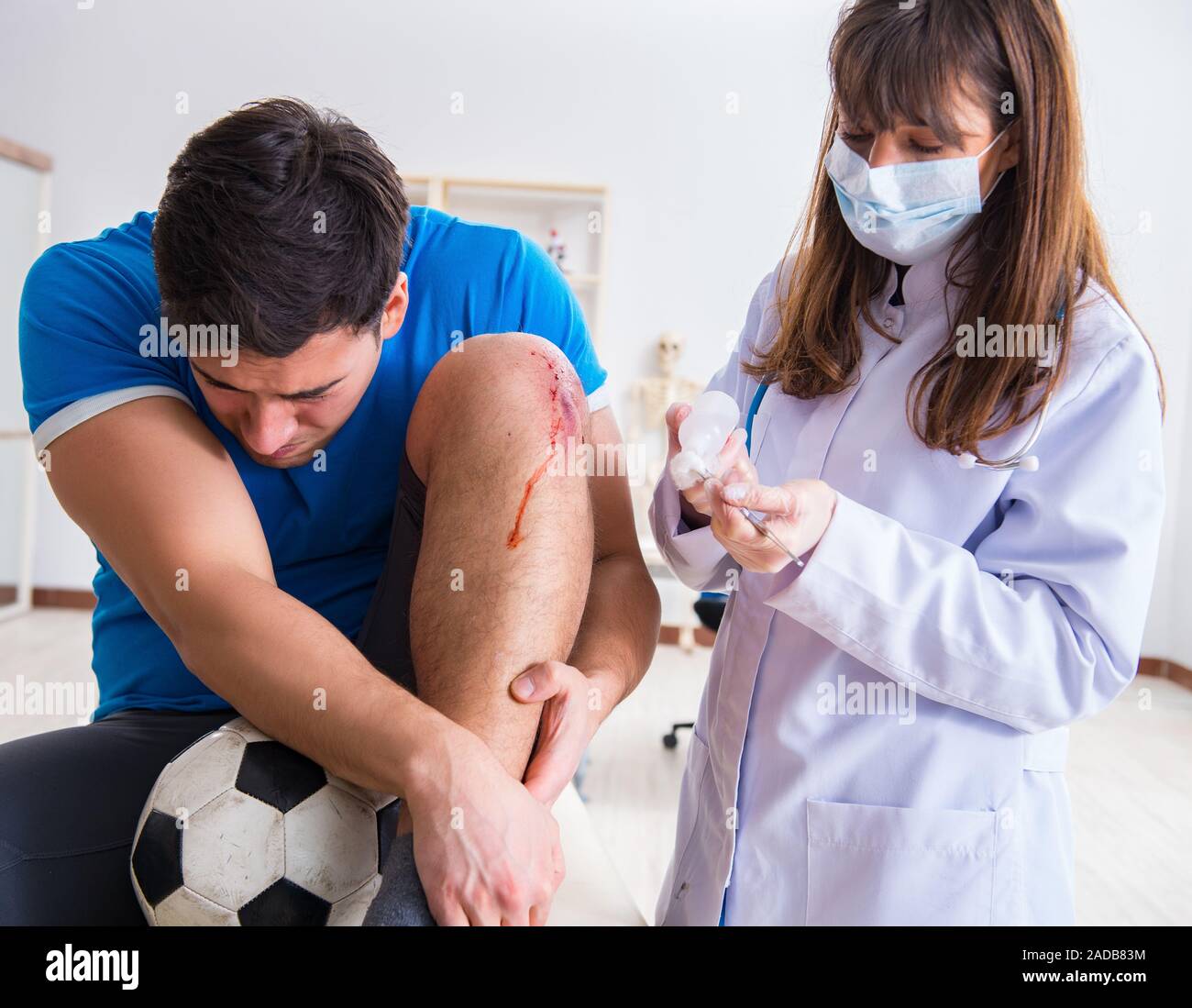 Football soccer player visiting doctor after injury Stock Photo - Alamy
