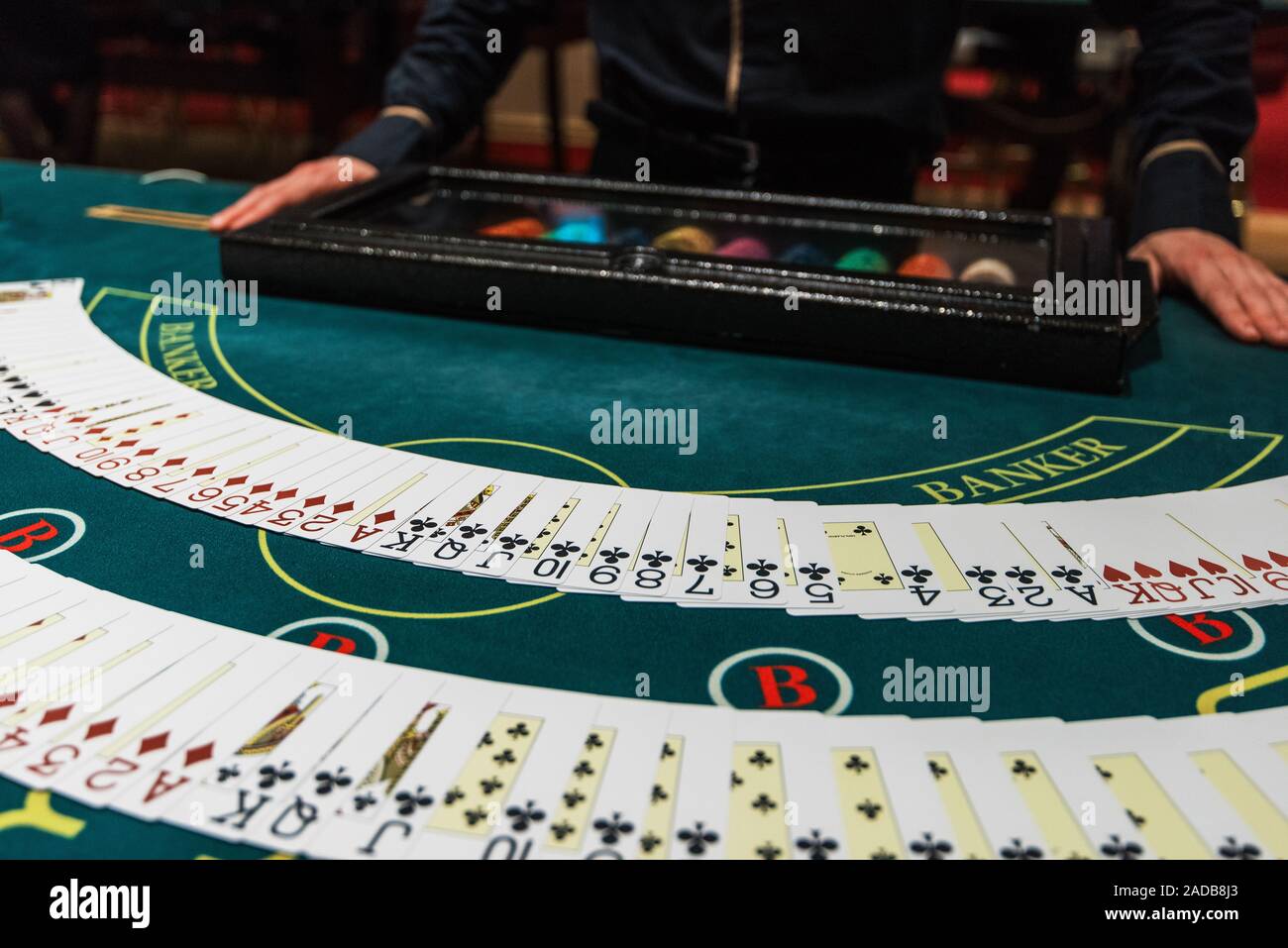 Professional croupier during cards Stock Photo - Alamy