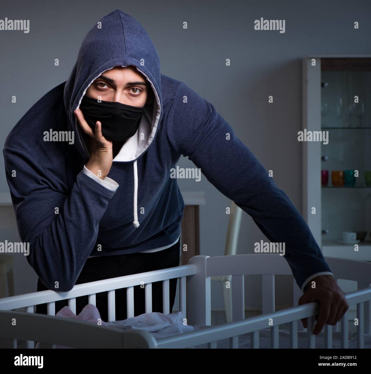 Criminal stealing baby in human child traficking concept Stock Photo ...
