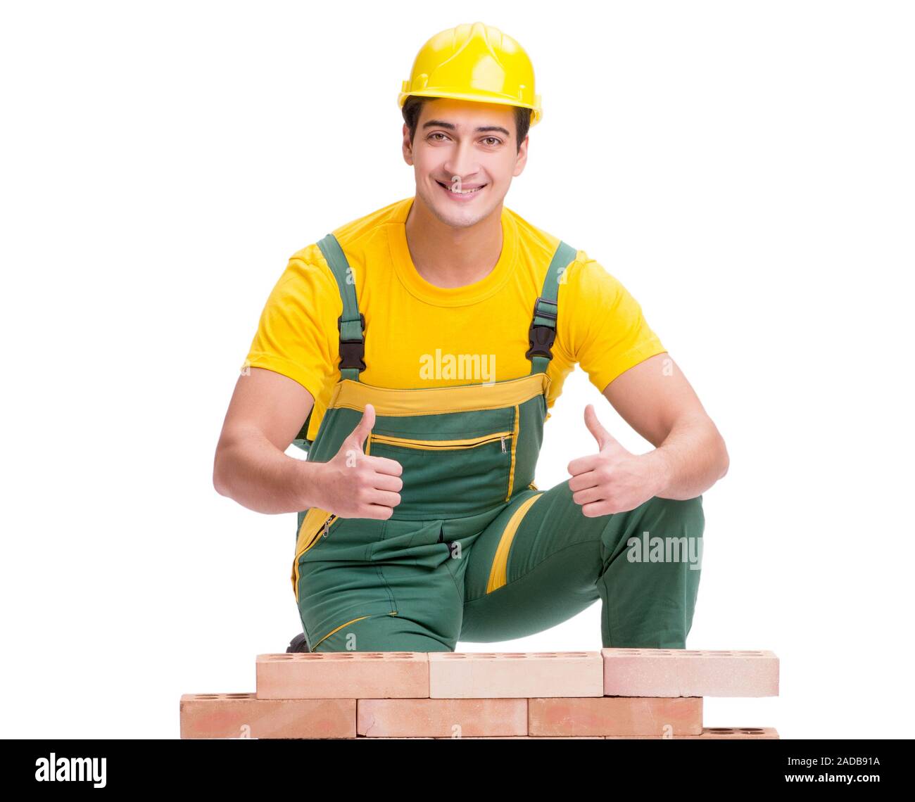 The handsome construction worker building brick wall Stock Photo - Alamy