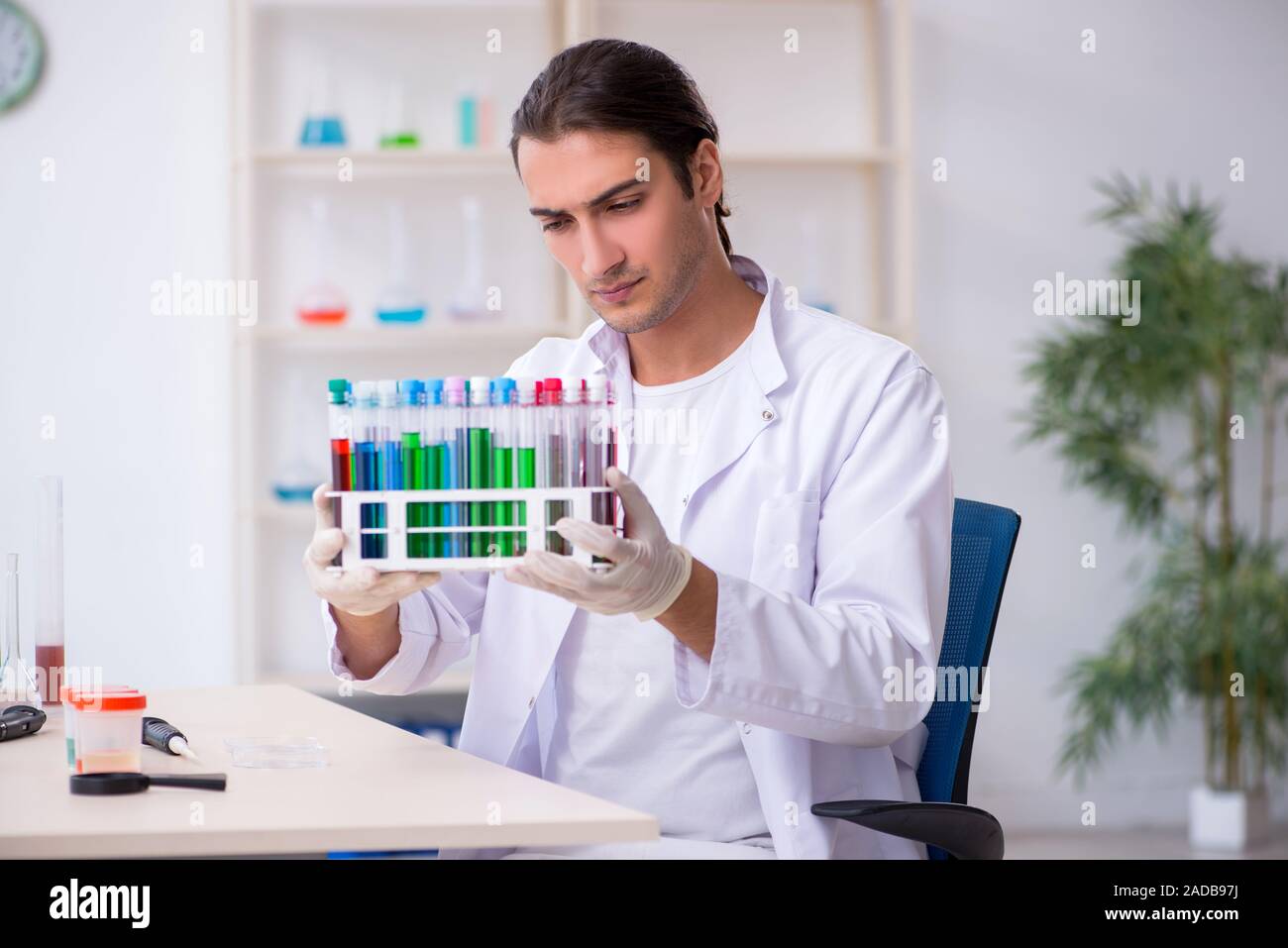 Chemist examining test tubes taking hi-res stock photography and images ...