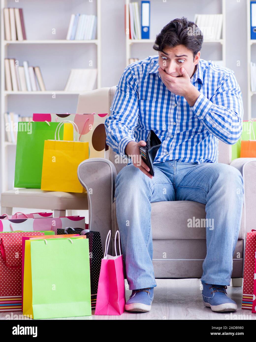 Young man after excessive shopping at home Stock Photo - Alamy