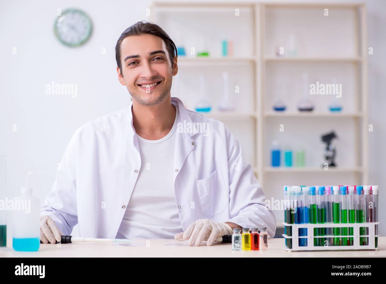 Chemist examining test tubes taking hi-res stock photography and images ...