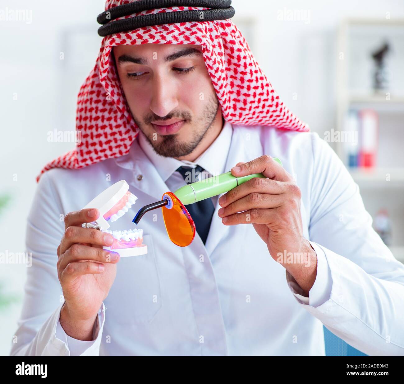 Arab dentist working on new teeth implant Stock Photo - Alamy