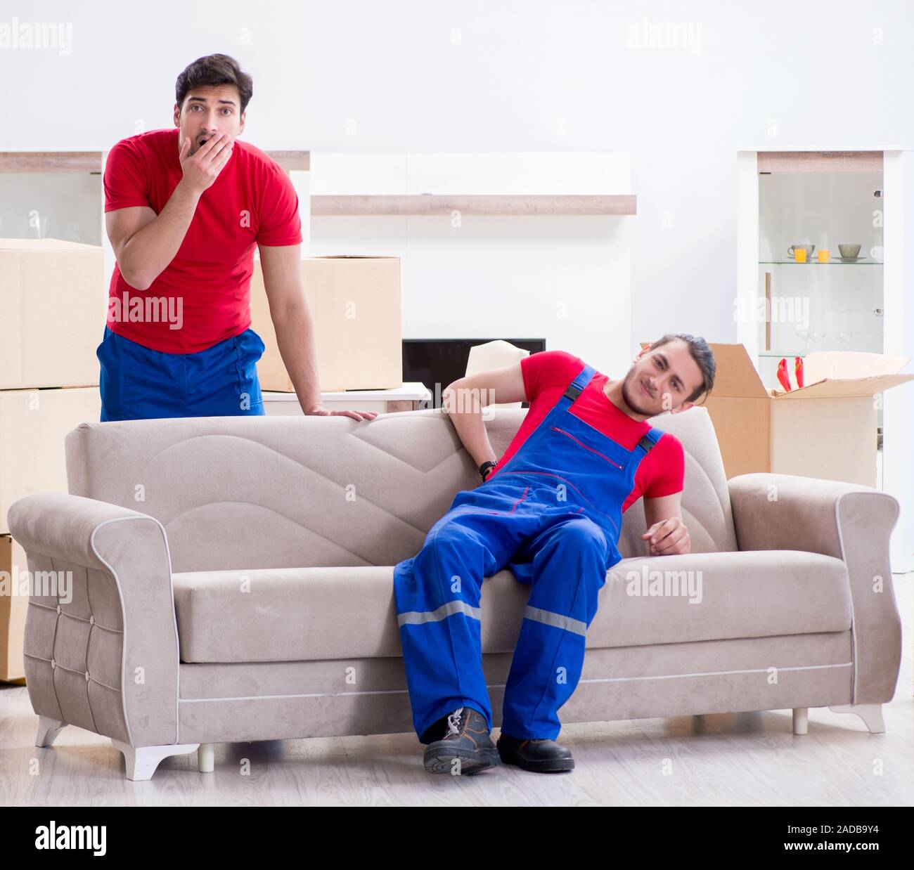 Two contractor employees moving personal belongings Stock Photo - Alamy