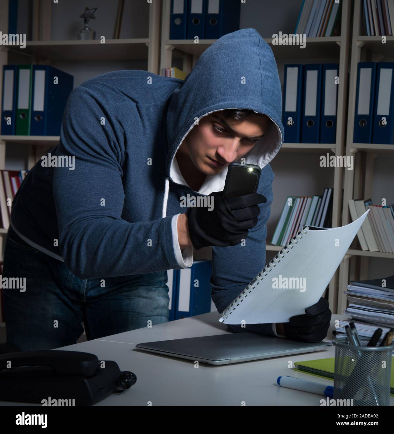 Young man in industrial espionage concept Stock Photo - Alamy