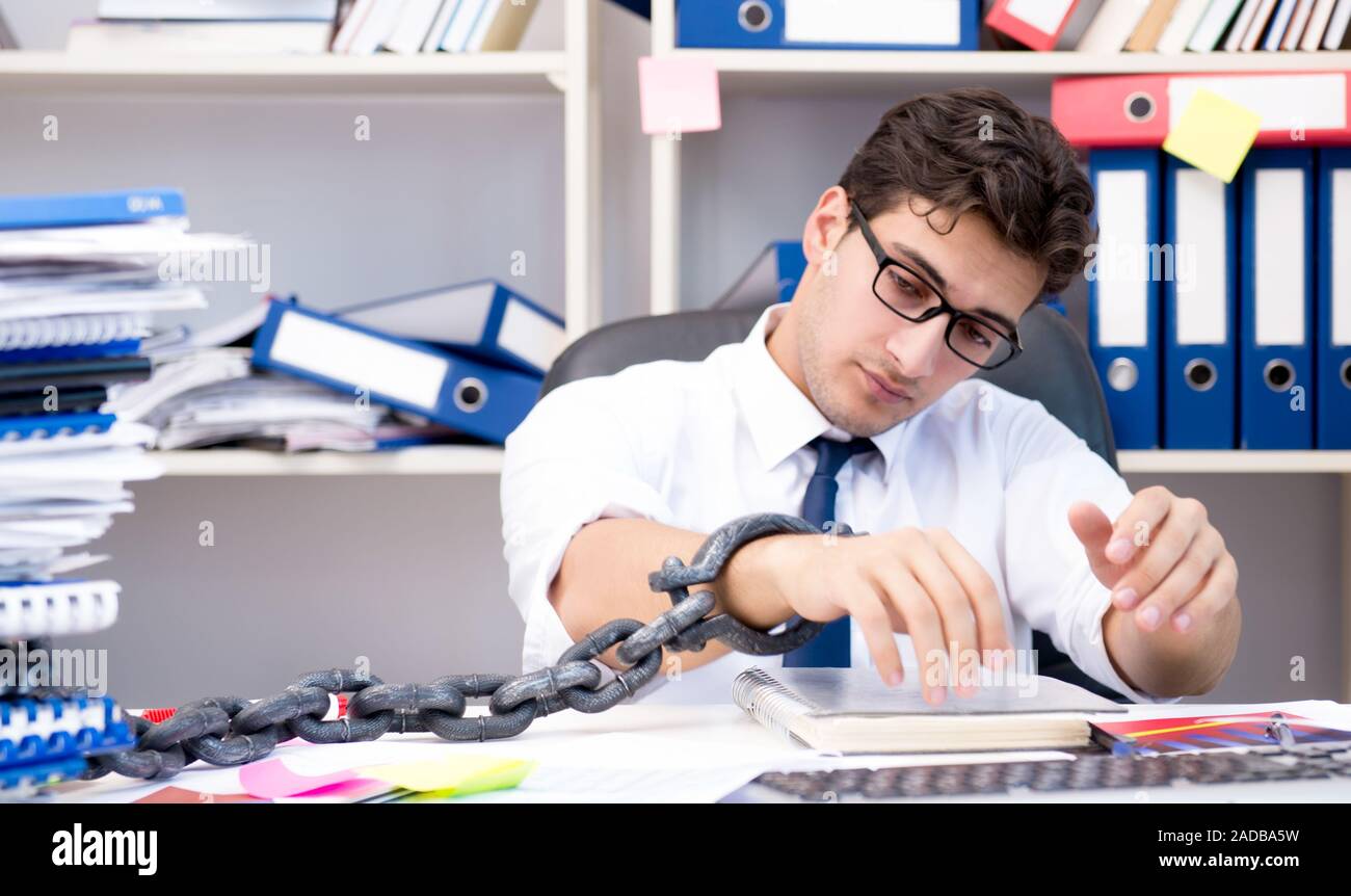 The employee attached and chained to his desk with chain Stock Photo ...