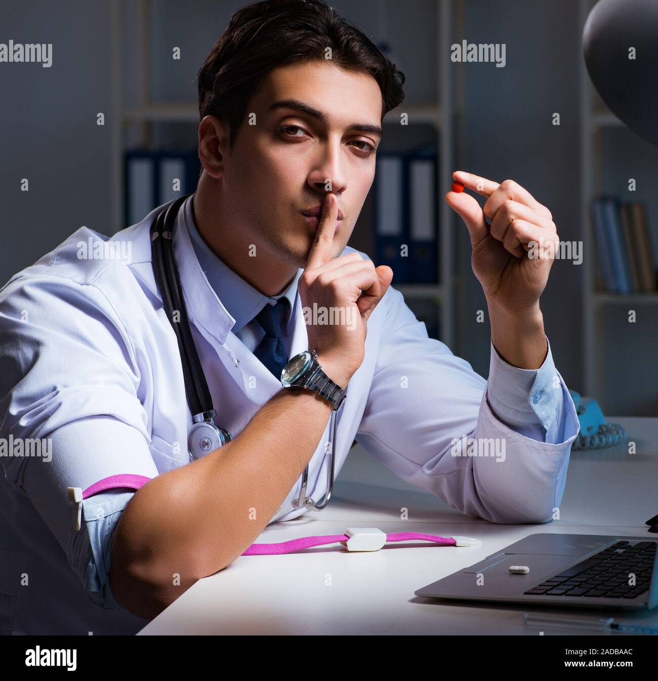Doctor drug addict staying late on hospital hi-res stock photography ...