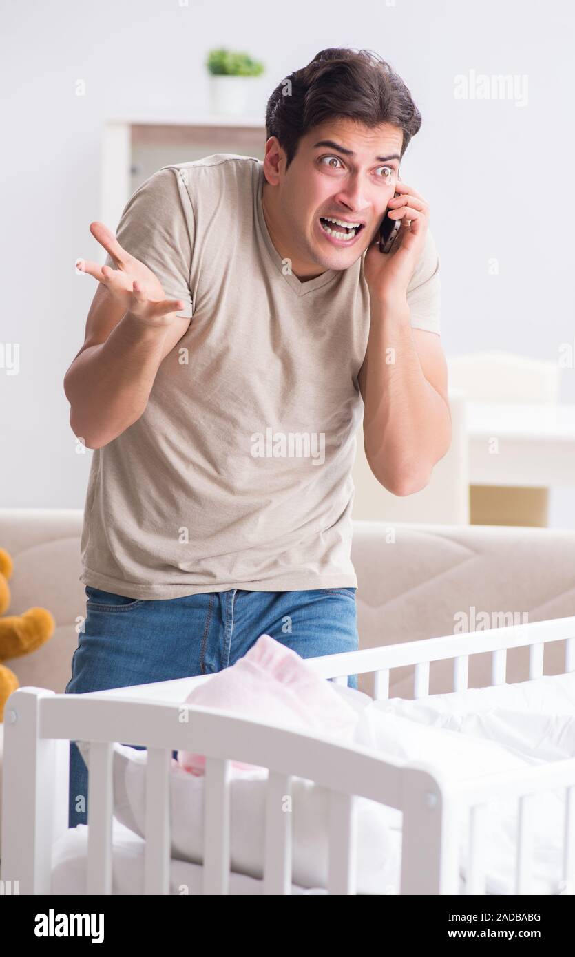 Young father dad frustrated at crying baby Stock Photo - Alamy
