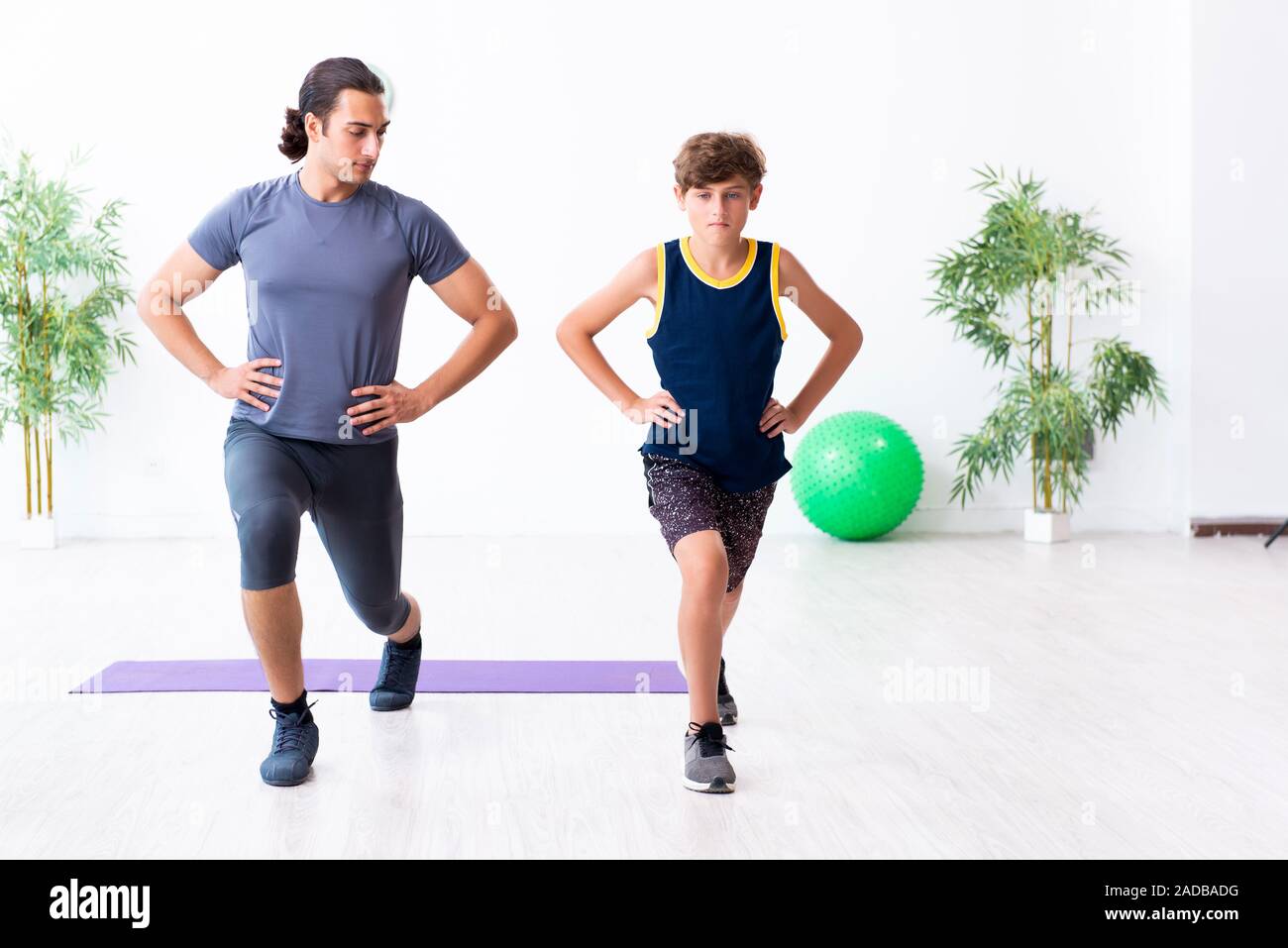 Young father and his son doing exercises Stock Photo - Alamy