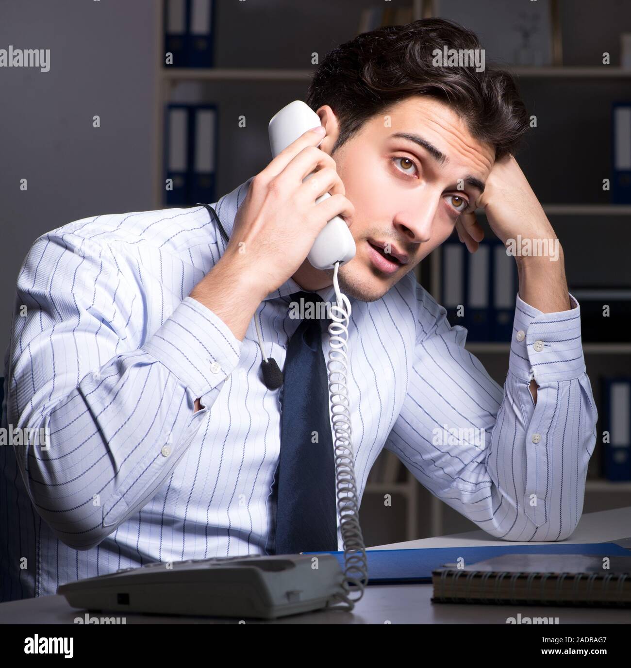 Tired and exhausted helpdesk operator during night shift Stock Photo ...