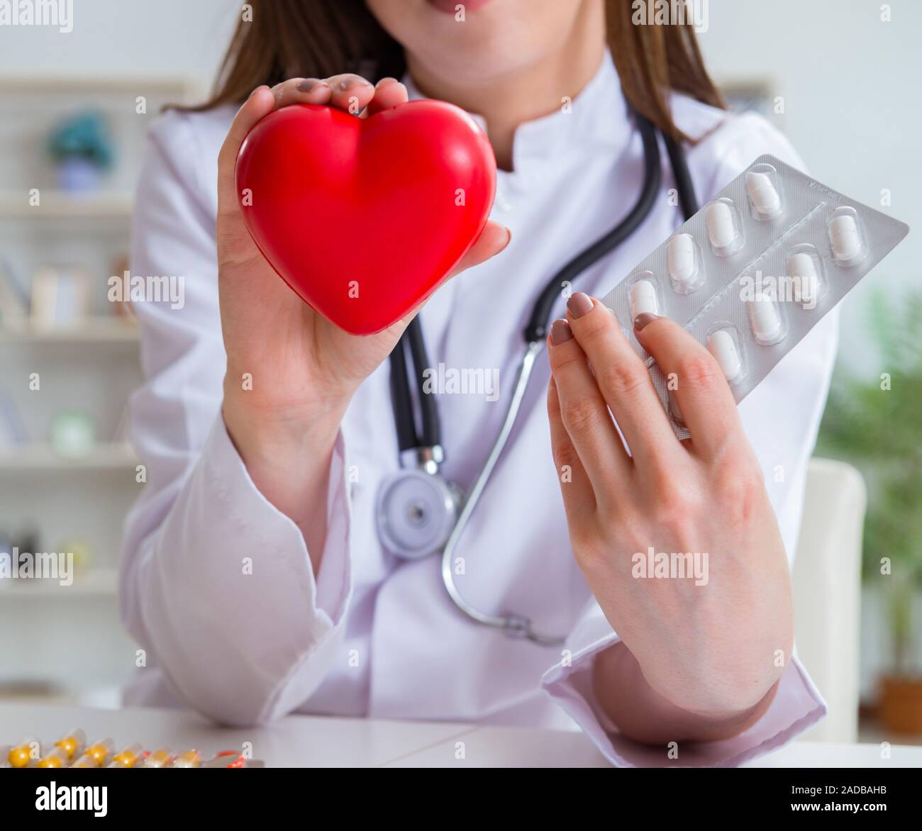 Doctor cardiologist with red heart in the hospital Stock Photo - Alamy