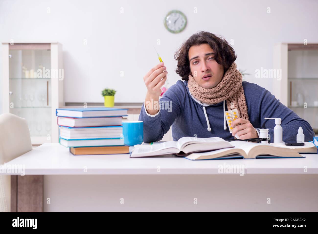 Sick male student suffering at home Stock Photo - Alamy