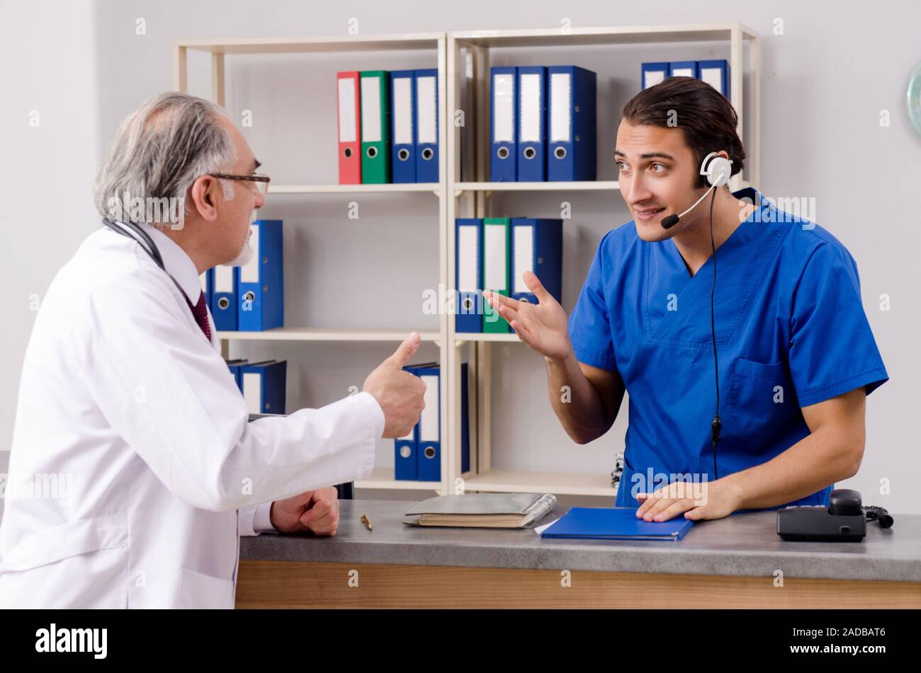 Two doctors talking at the reception in hospital Stock Photo - Alamy