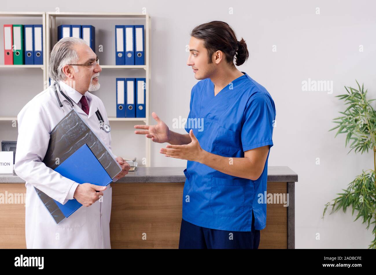 Two doctors talking at the reception in hospital Stock Photo - Alamy