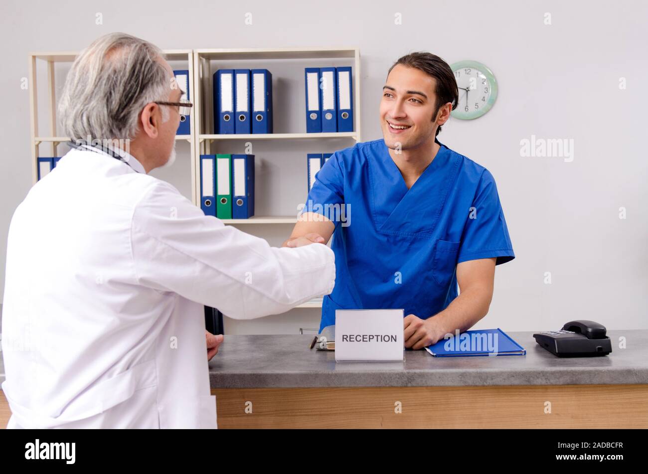 Two doctors talking at the reception in hospital Stock Photo - Alamy