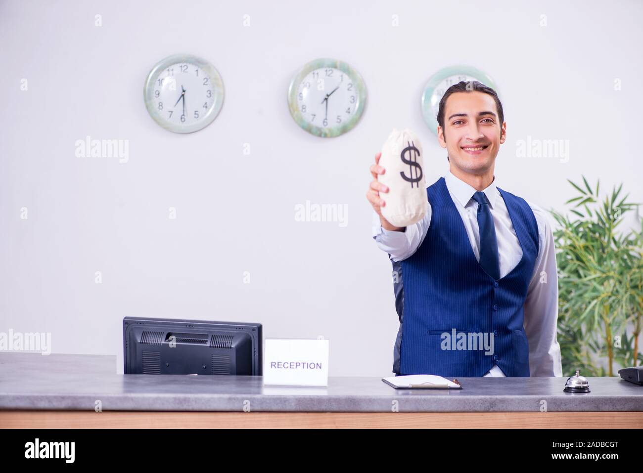 Young man receptionist at the hotel counter Stock Photo - Alamy