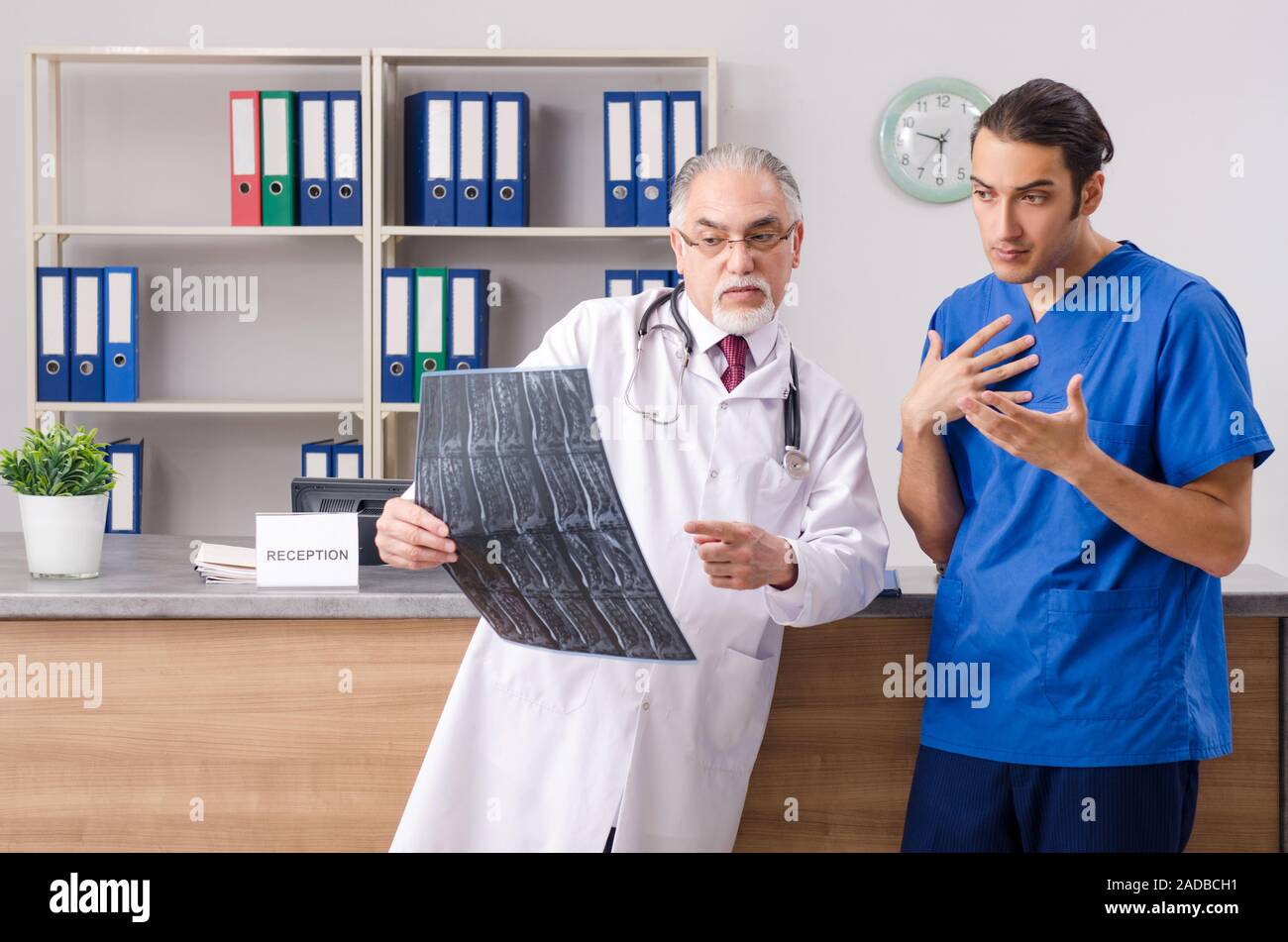 Two doctors talking at the reception in hospital Stock Photo - Alamy