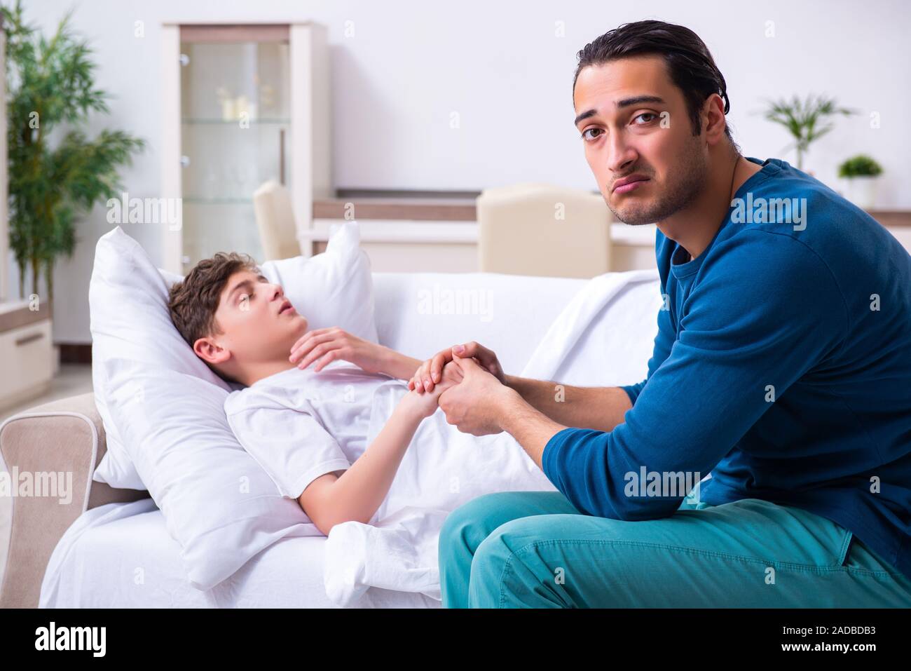 Young father caring for sick son Stock Photo - Alamy