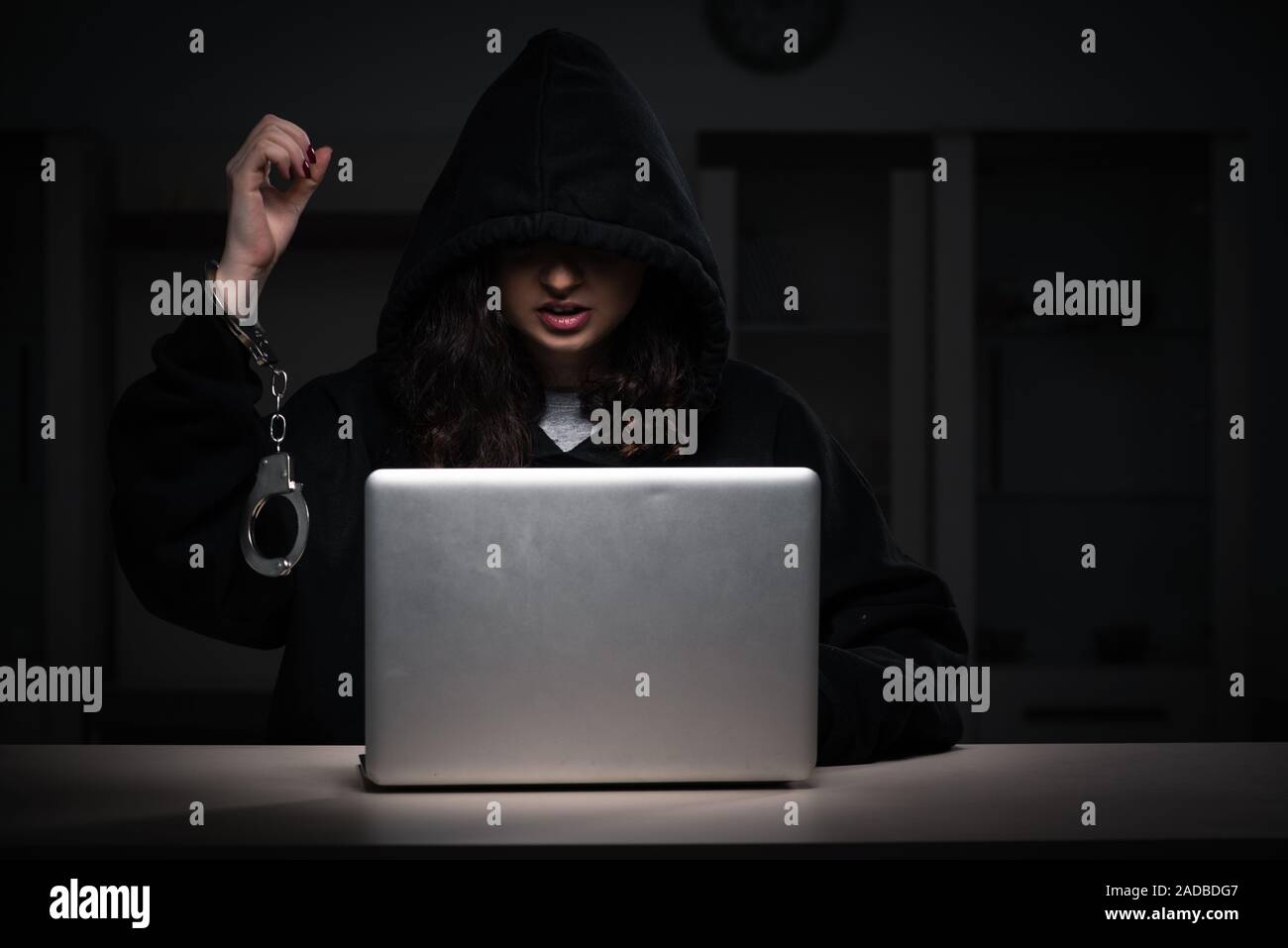Female hacker hacking security firewall late in office Stock Photo - Alamy
