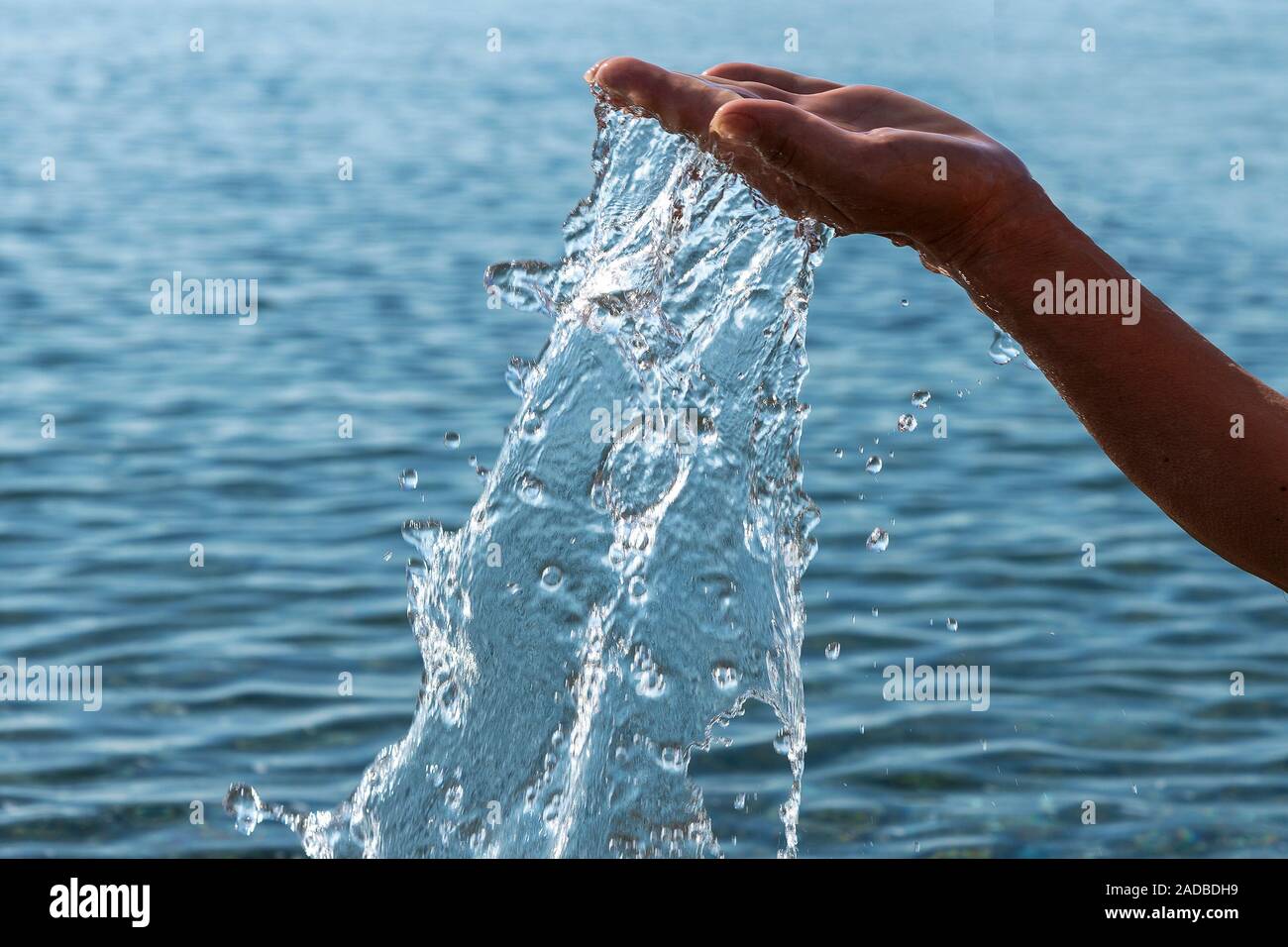 Splashing sea wter and human hand Stock Photo - Alamy
