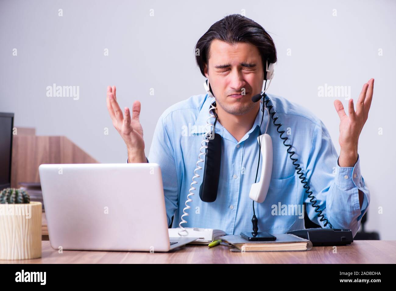 Call center operator working at his desk Stock Photo - Alamy