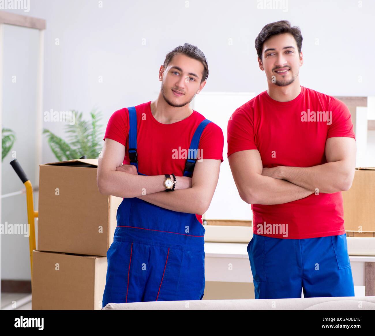 Two contractor employees moving personal belongings Stock Photo - Alamy