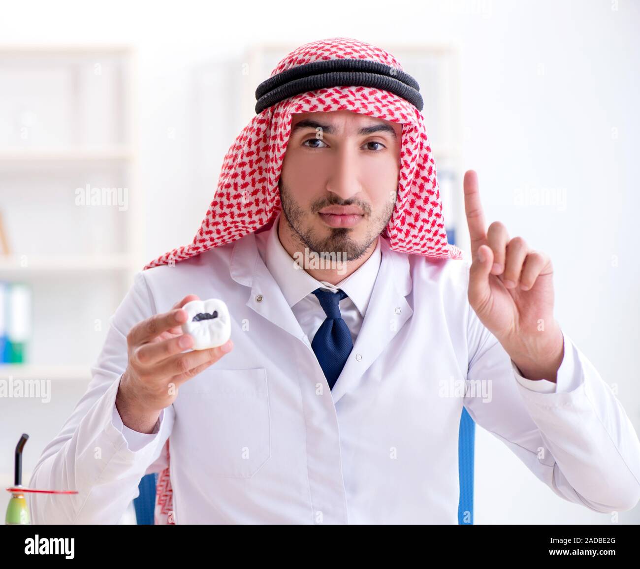Arab dentist working on new teeth implant Stock Photo - Alamy