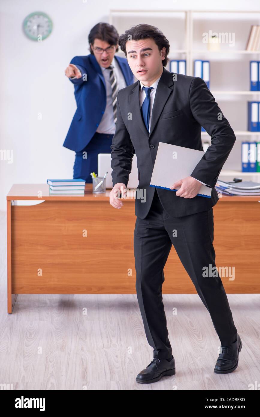 Boss and his male assistant working in the office Stock Photo - Alamy