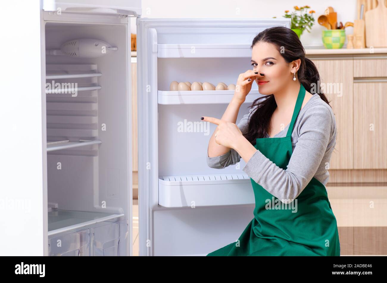 Young woman cleaning fridge in hygiene concept Stock Photo - Alamy