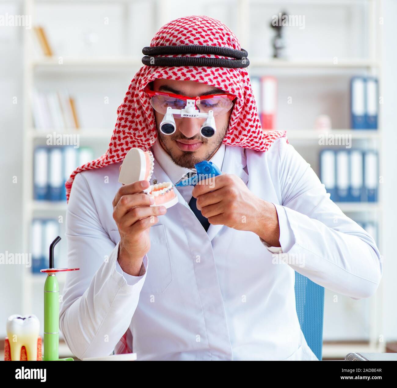 Arab dentist working on new teeth implant Stock Photo - Alamy