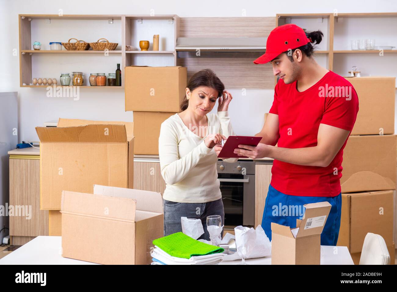 Young male contractor and female customer in moving concept Stock Photo ...