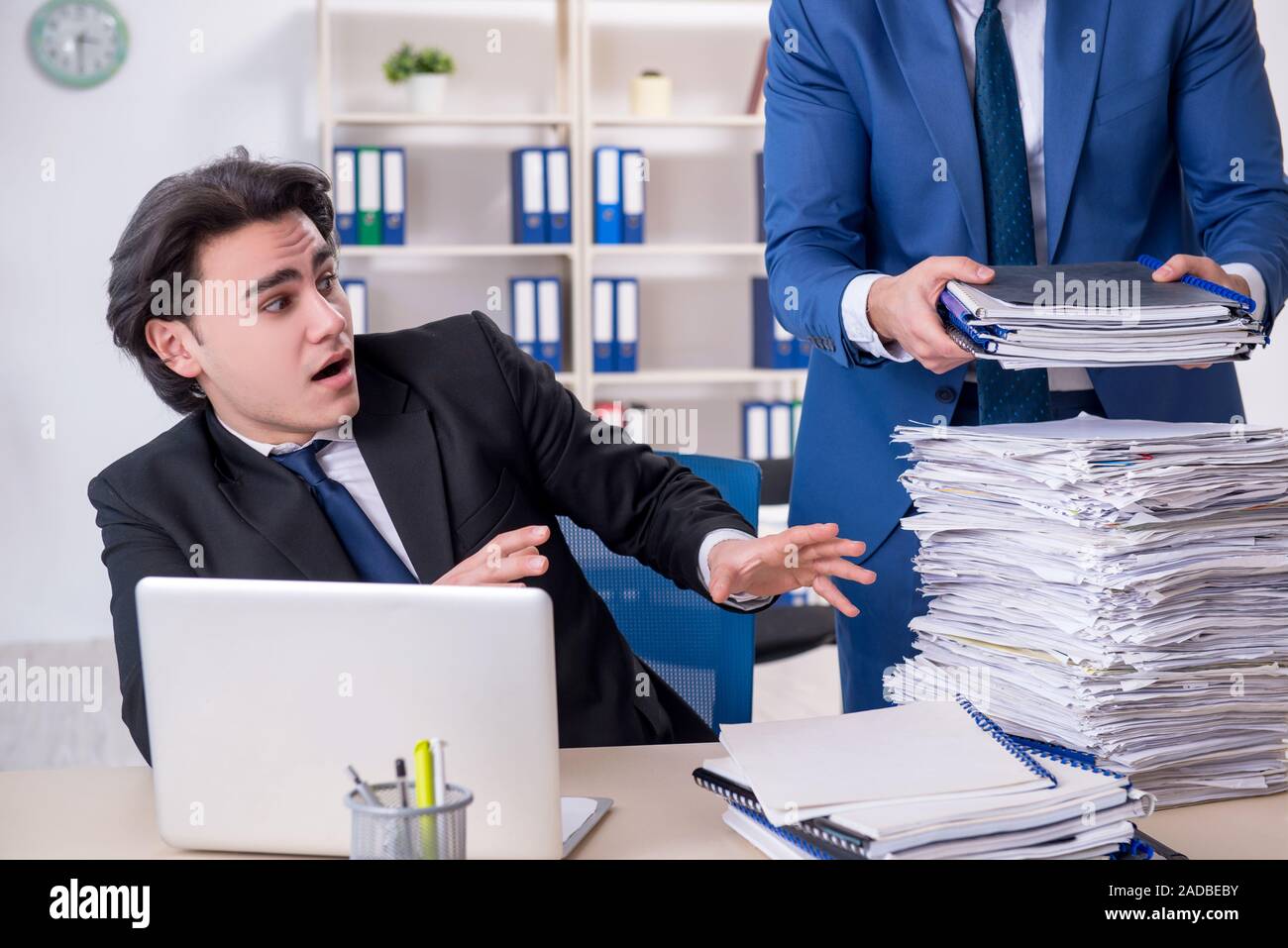 Two male colleagues unhappy with excessive work Stock Photo - Alamy