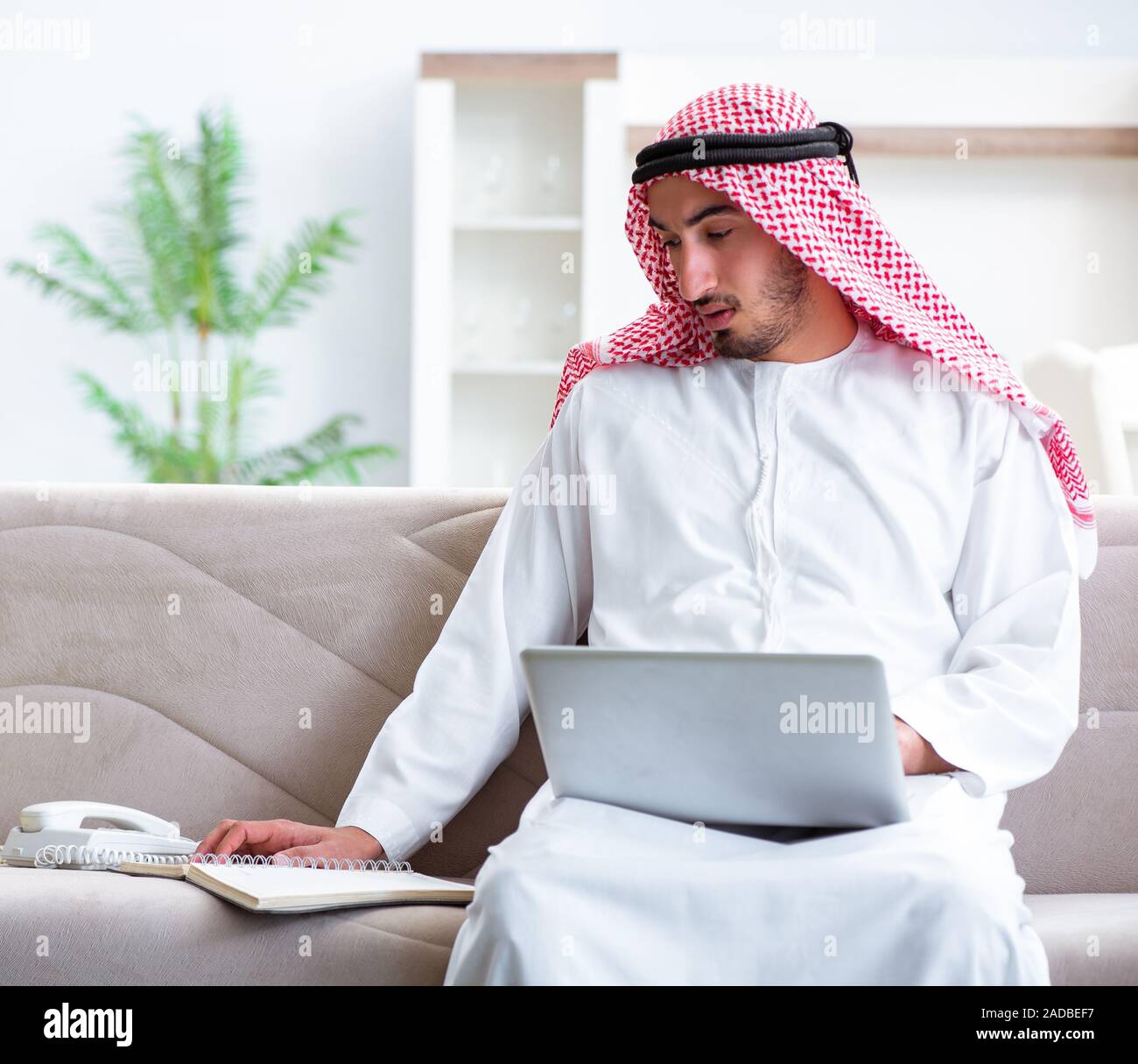 Arab man working at home on his work Stock Photo - Alamy