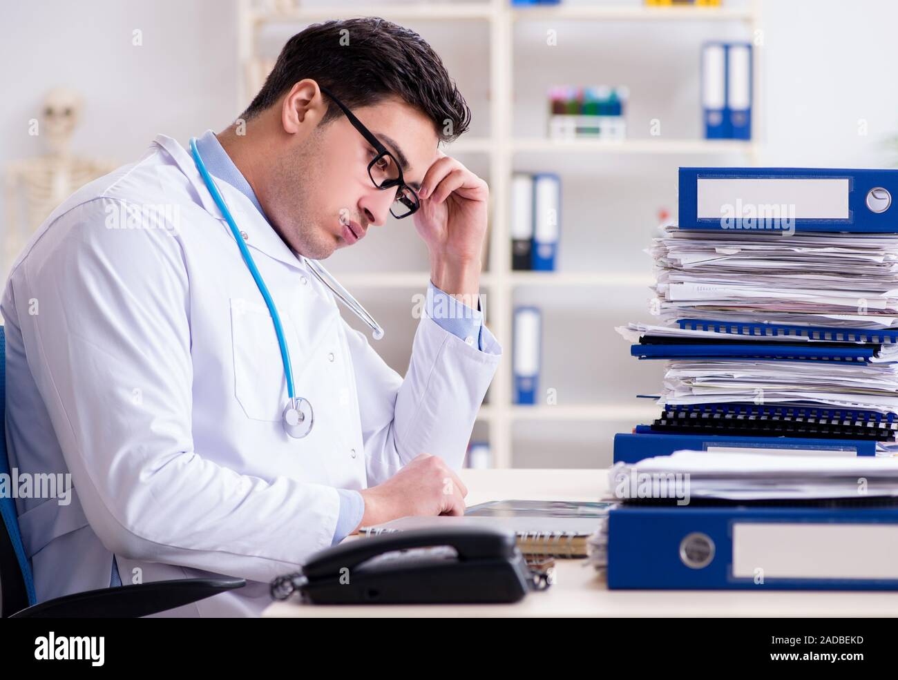 Busy doctor with too much work in hospital Stock Photo - Alamy