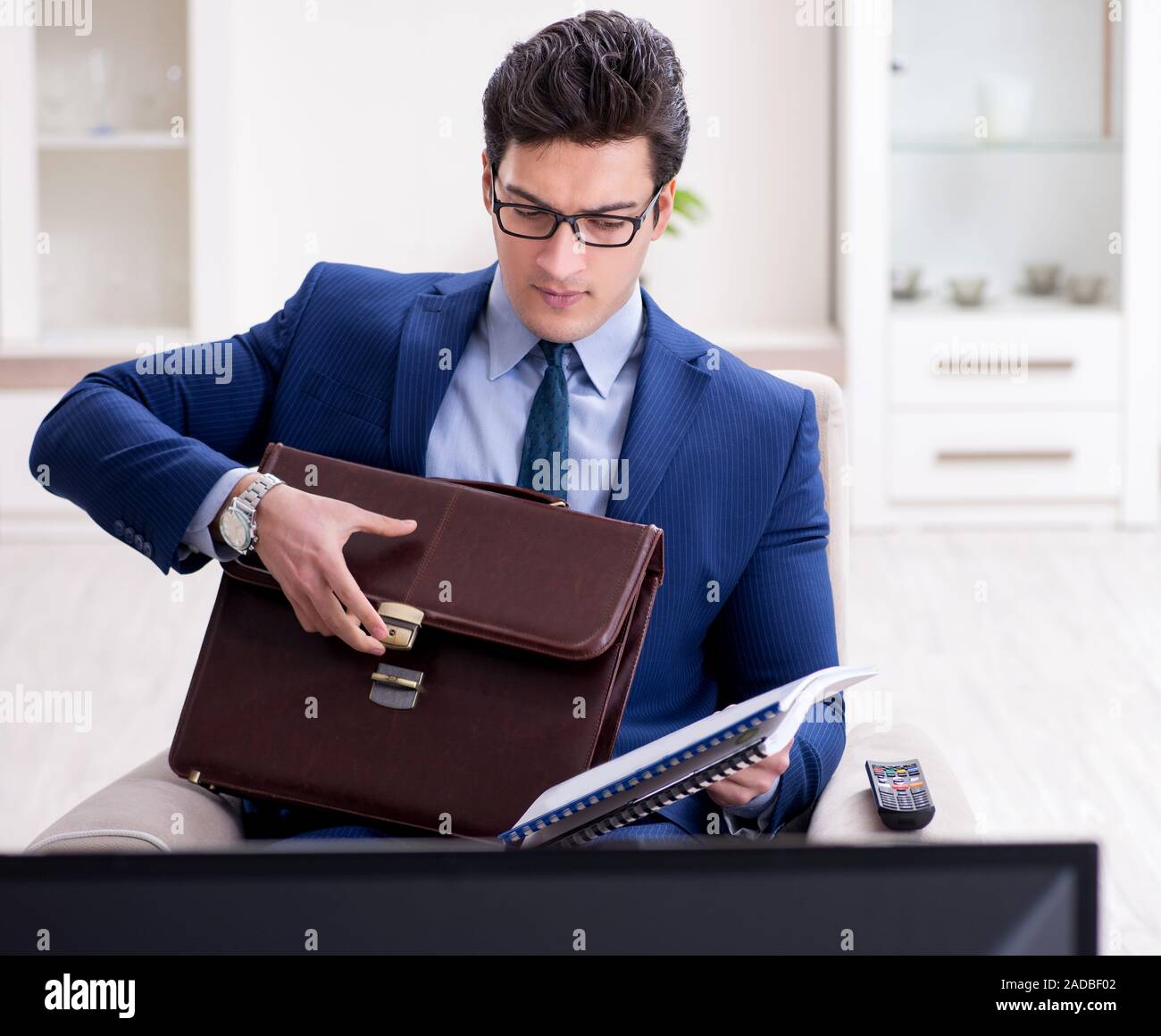 Businessman watching tv in the office Stock Photo - Alamy