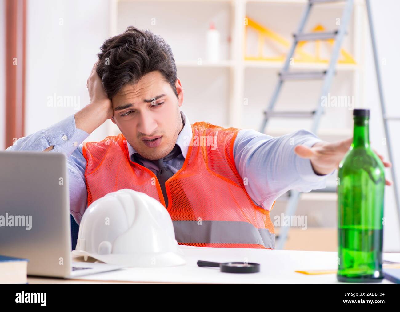 Drunk engineer working in the workshop Stock Photo - Alamy