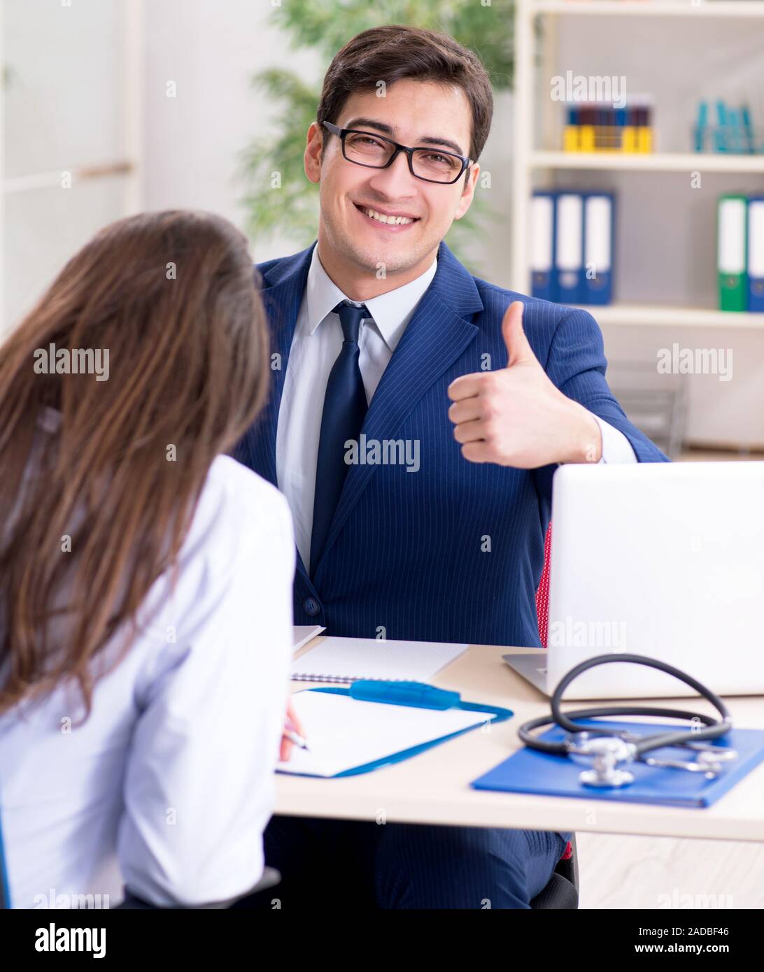 Man signing medical insurance contract Stock Photo - Alamy