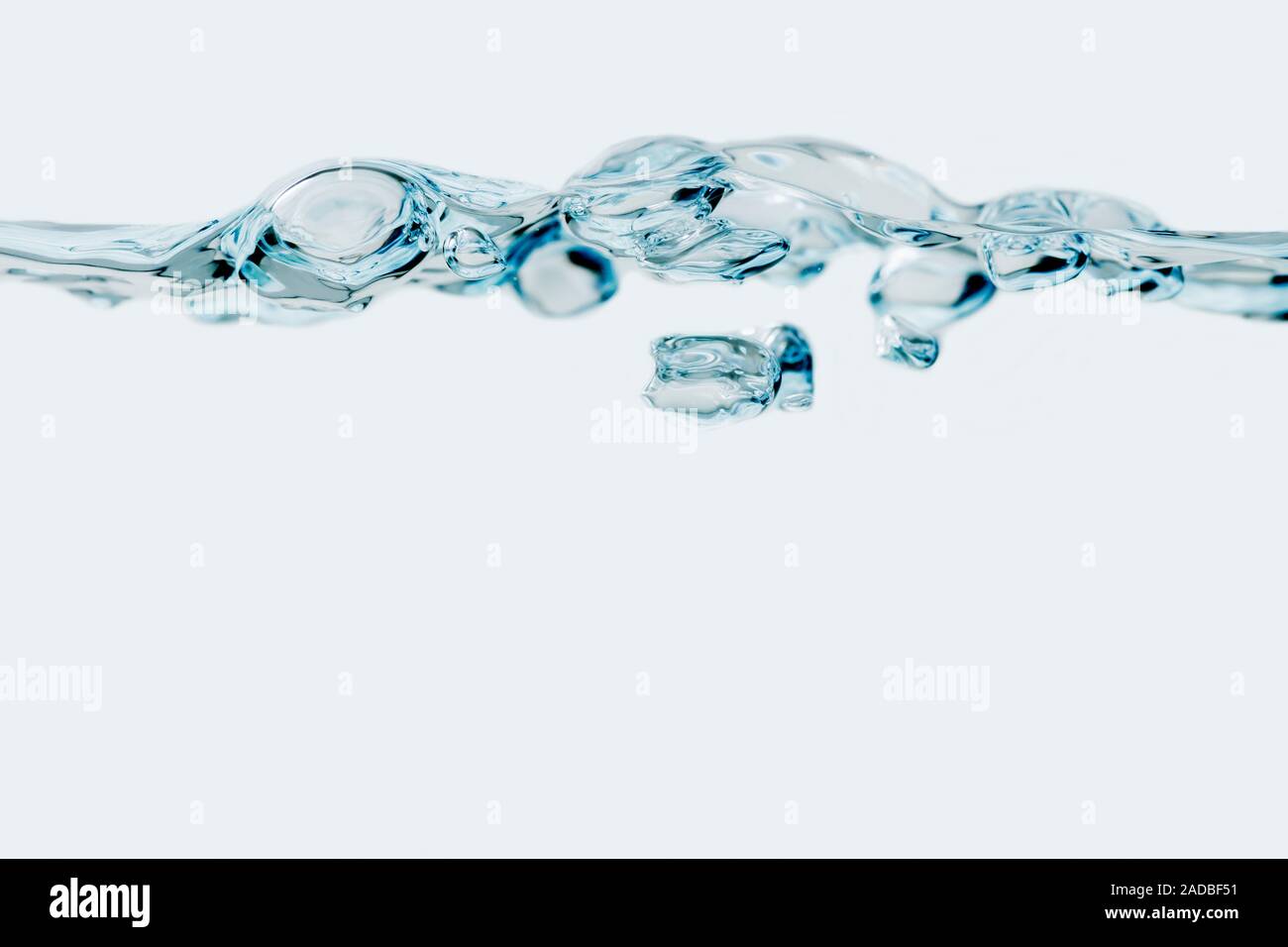 Studio shot of a row of moving bubbles at the water surface in front of ...