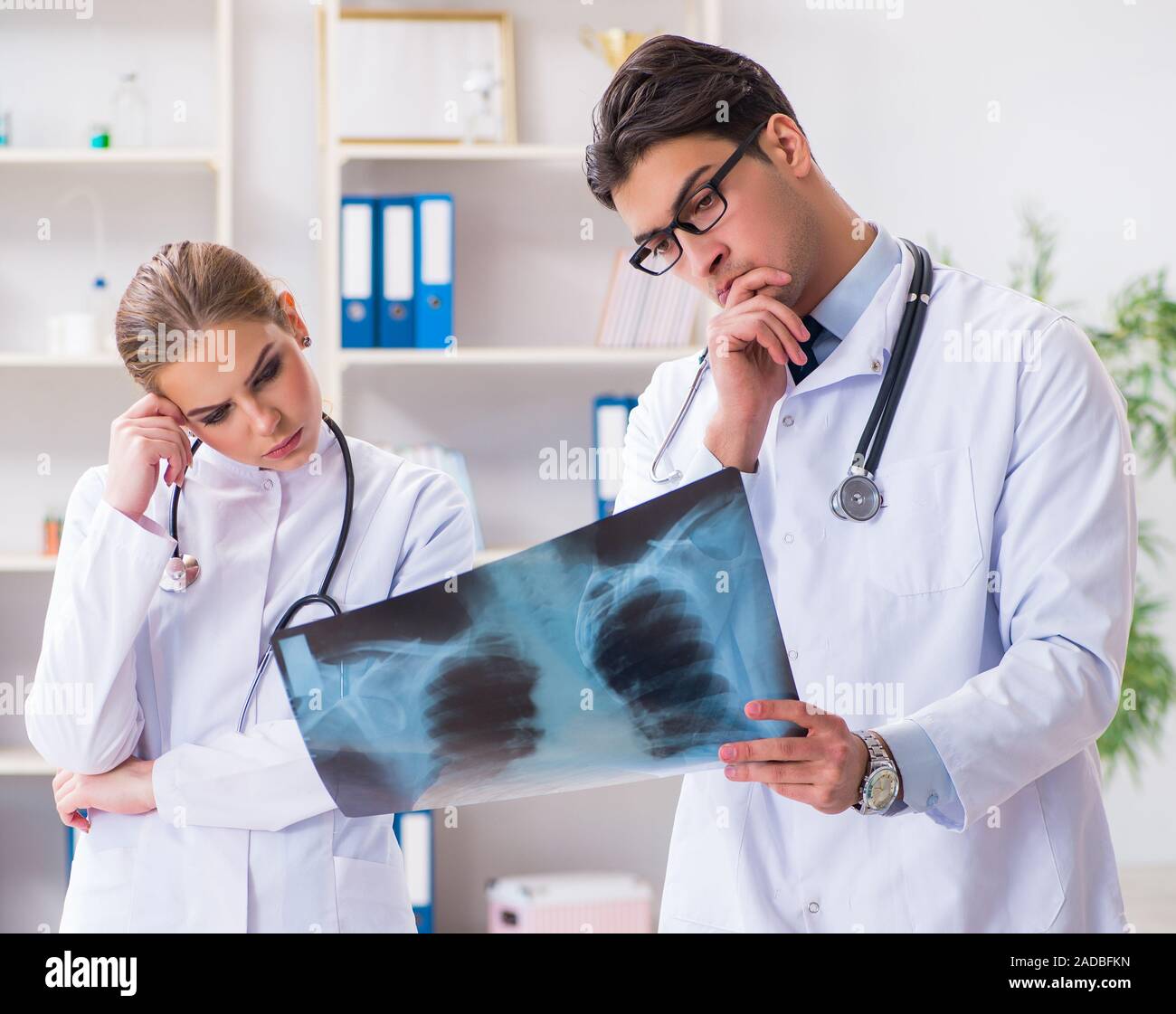 Two doctors examining x-ray images of patient for diagnosis Stock Photo ...