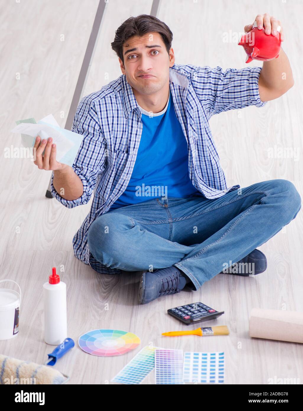 Young man overspending his budget in refurbishment project Stock Photo ...