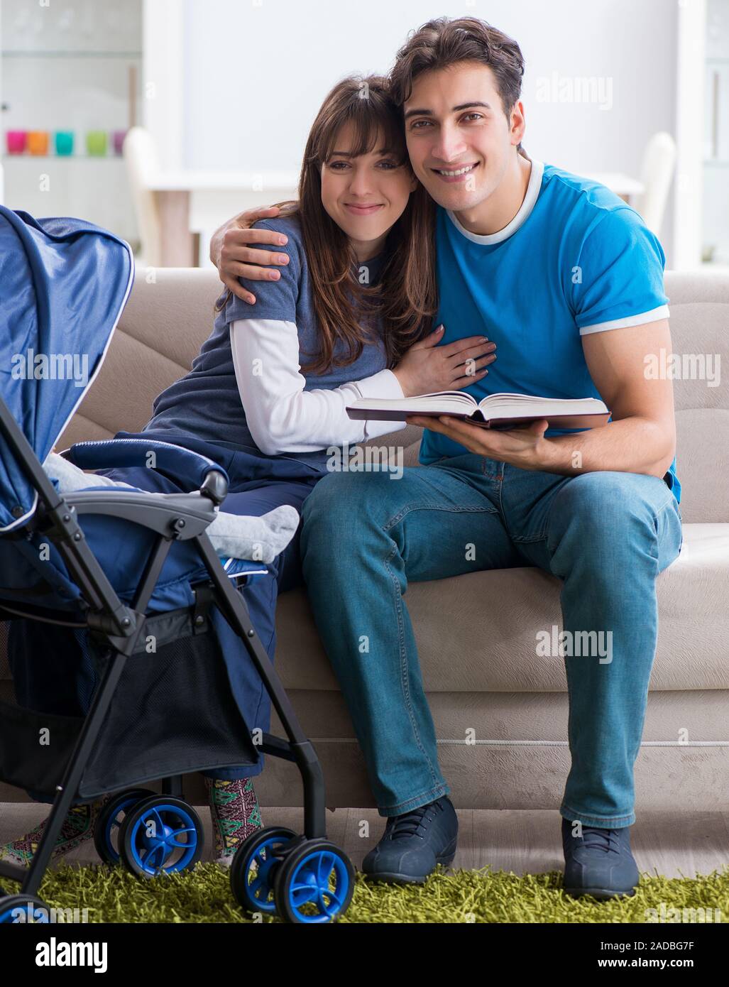 Young parents with their newborn baby in baby pram sitting on th Stock ...
