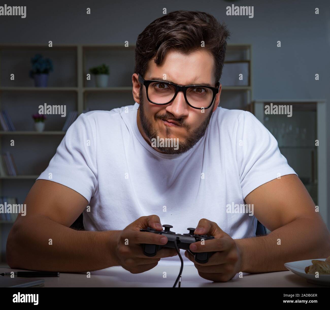 The young man playing games long hours late in the office Stock Photo ...