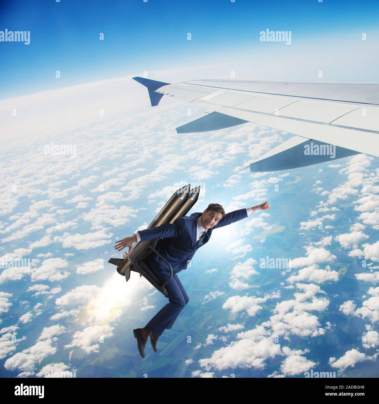 Businessman flying next to commercial flight Stock Photo - Alamy