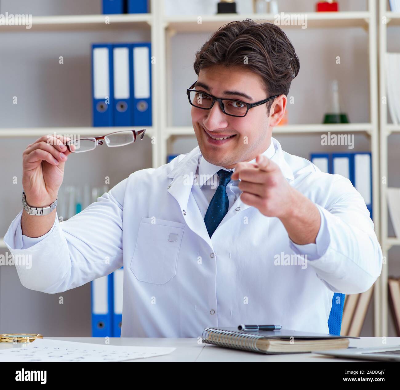 Doctor optician prescribing holding optical glasses Stock Photo - Alamy