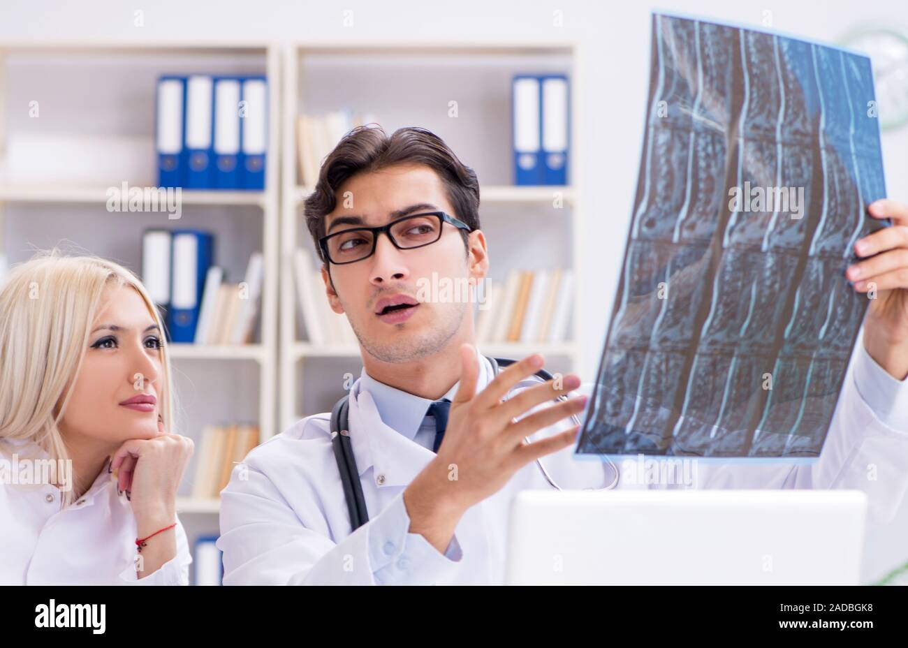 Two doctors examining x-ray images of patient for diagnosis Stock Photo ...