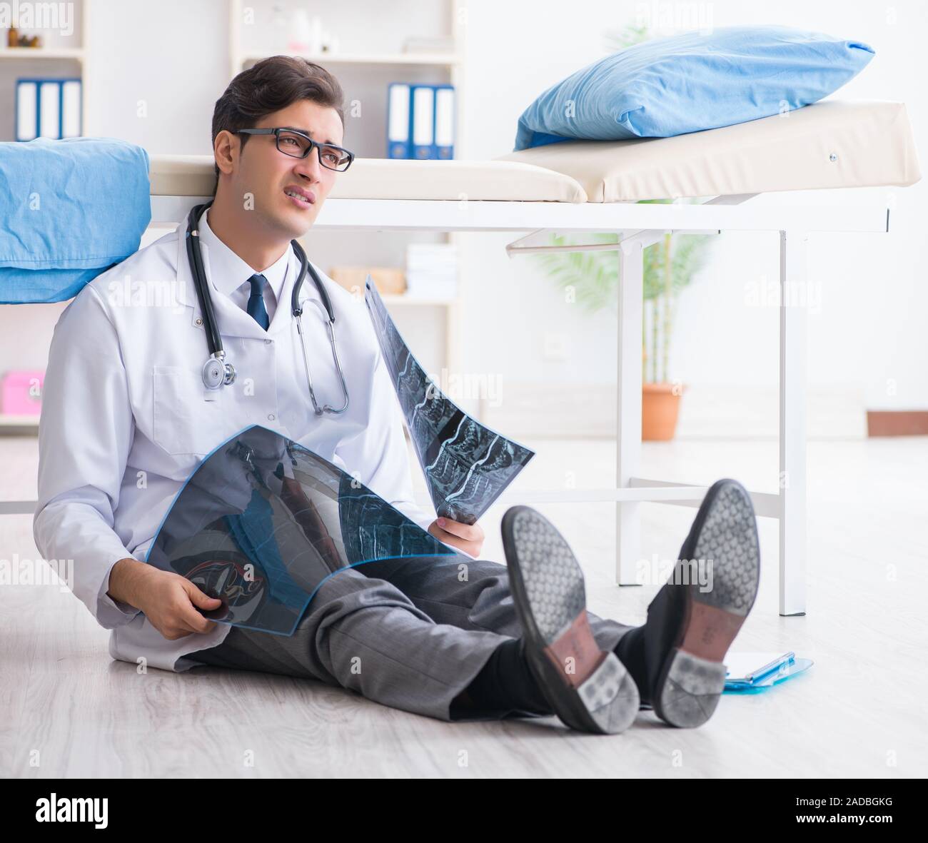 Doctor sitting on the floor in hospital Stock Photo - Alamy